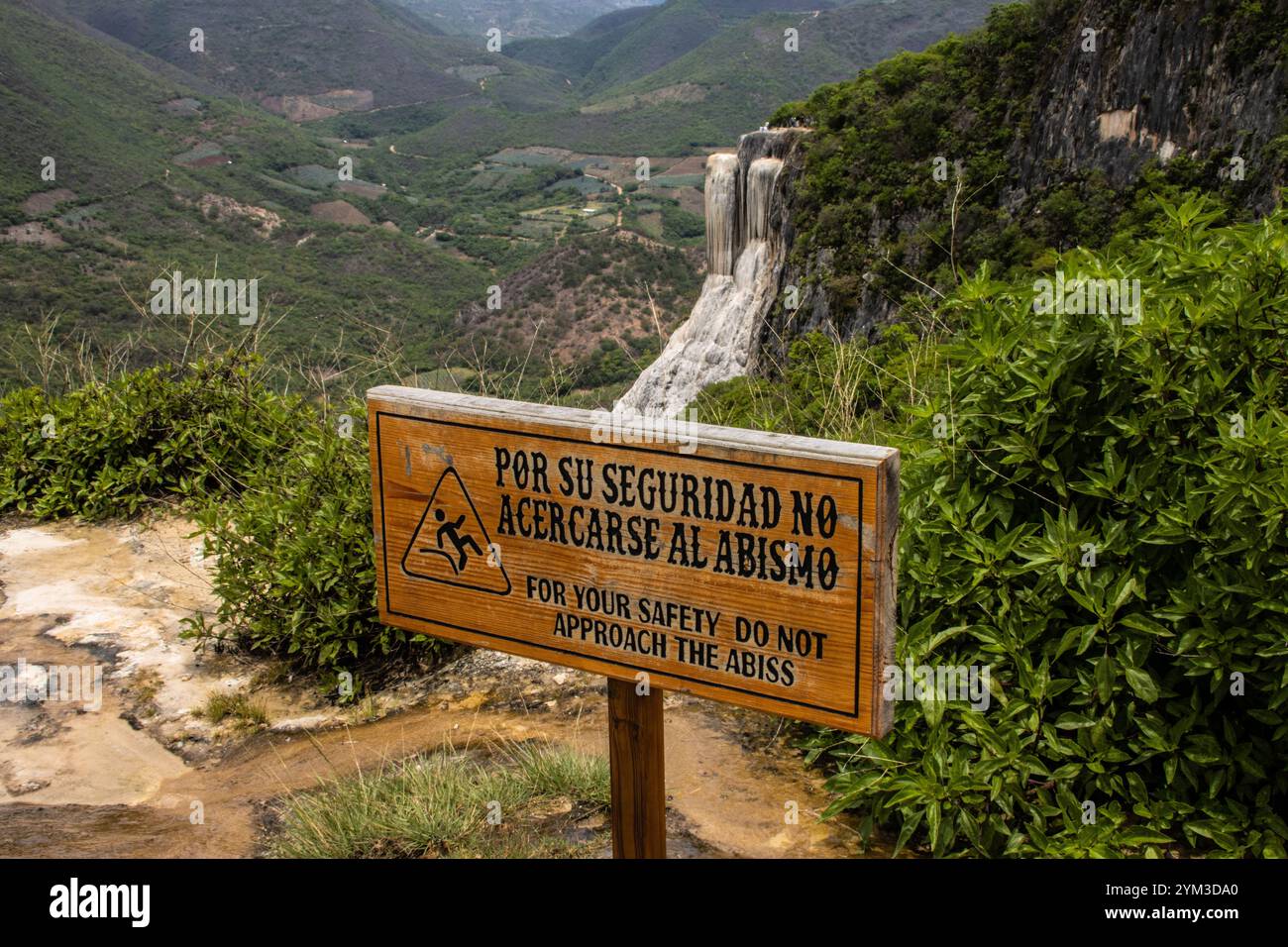 Petrified waterfall of Hierve el Agua, Oaxaca Mexico, with danger sign ...