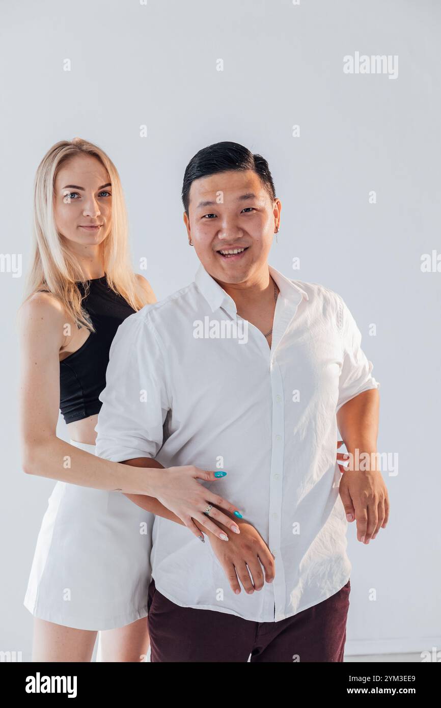 Man and woman standing side by side hugging Stock Photo - Alamy