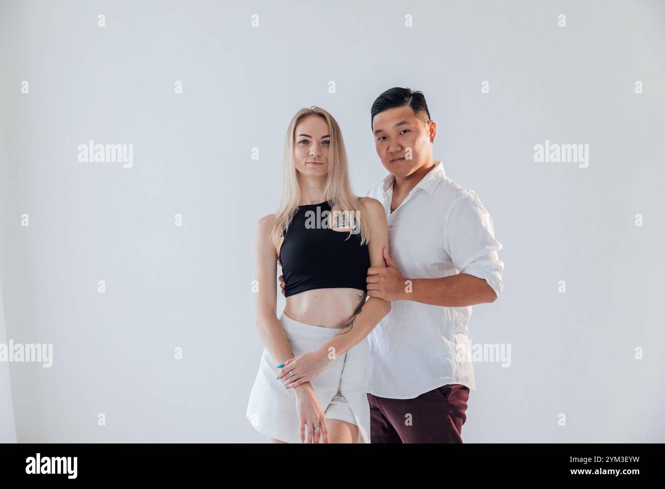 Man and woman standing side by side hugging Stock Photo - Alamy