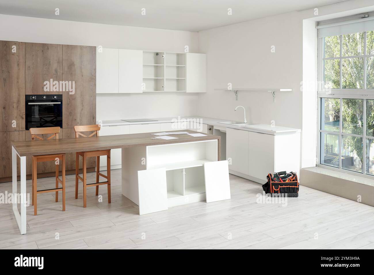 Interior of light kitchen with counters, table and tool bag Stock Photo ...