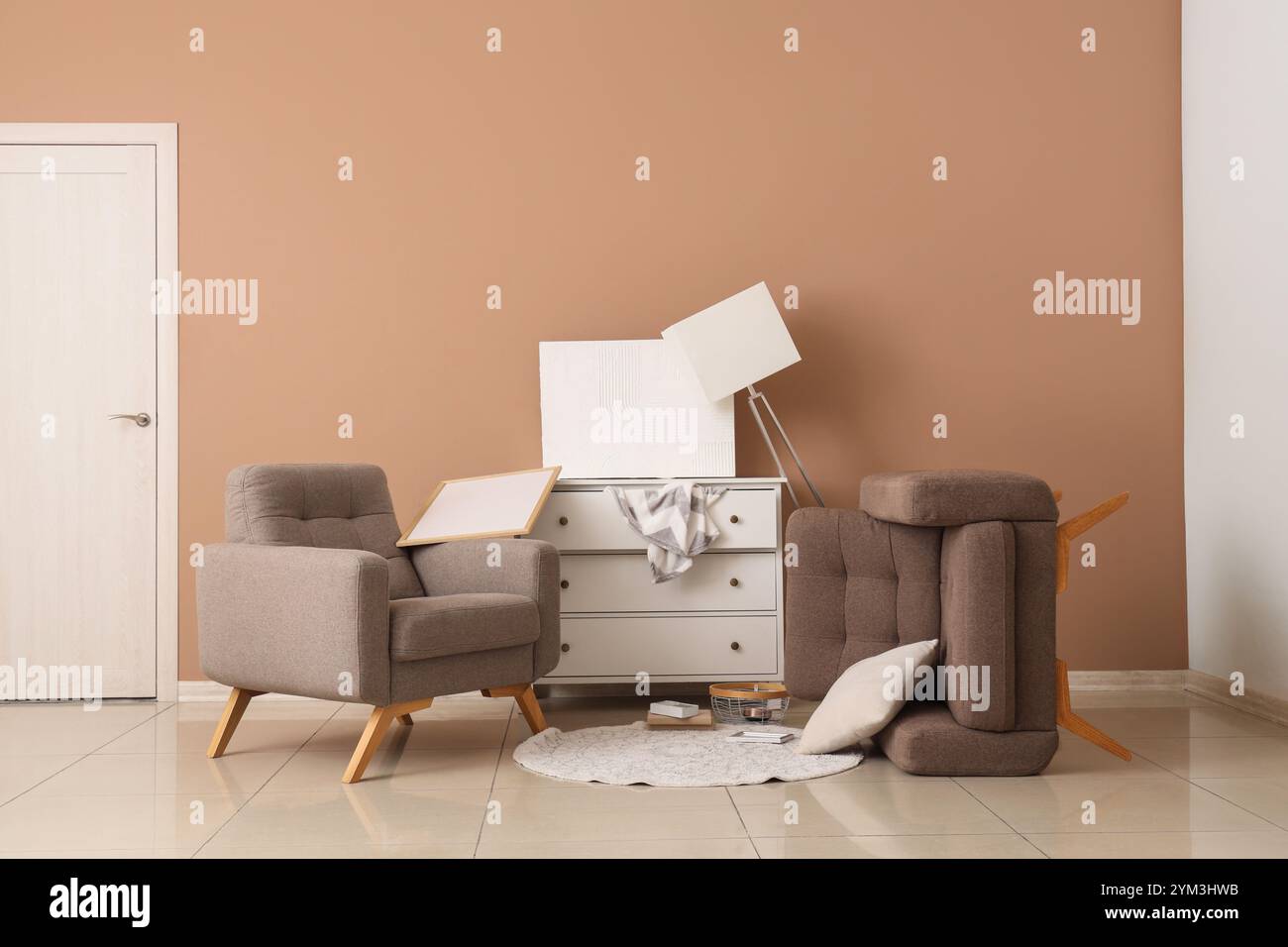 Interior of messy room with armchairs and overturned furniture after ...