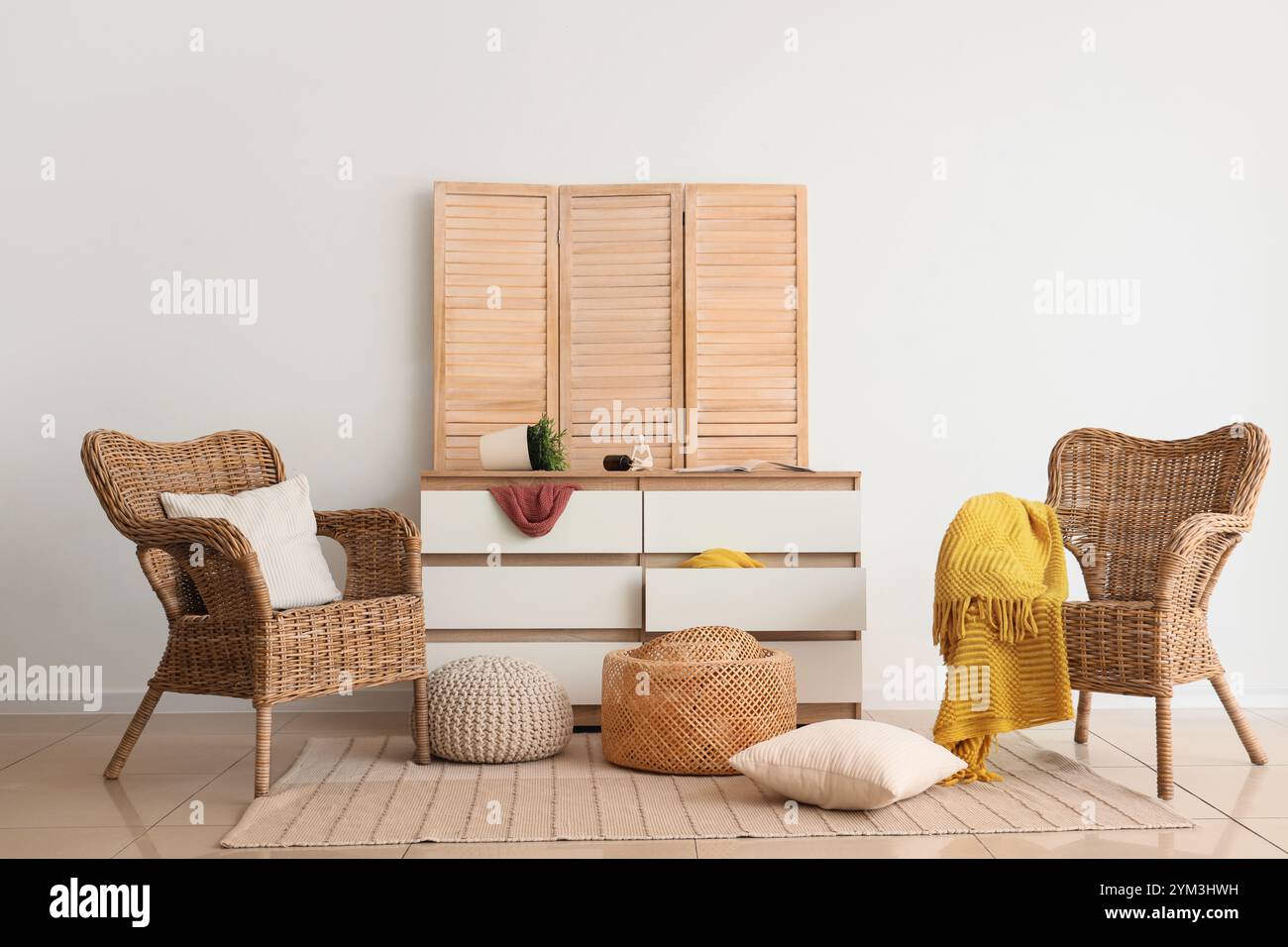 Interior of messy room with wicker armchairs and overturned furniture ...