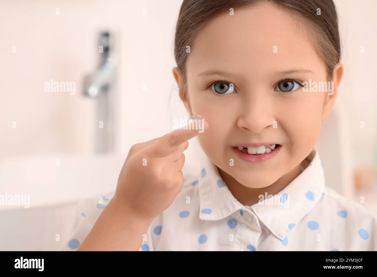 Cute little girl putting contact lens in bathroom, closeup Stock Photo ...