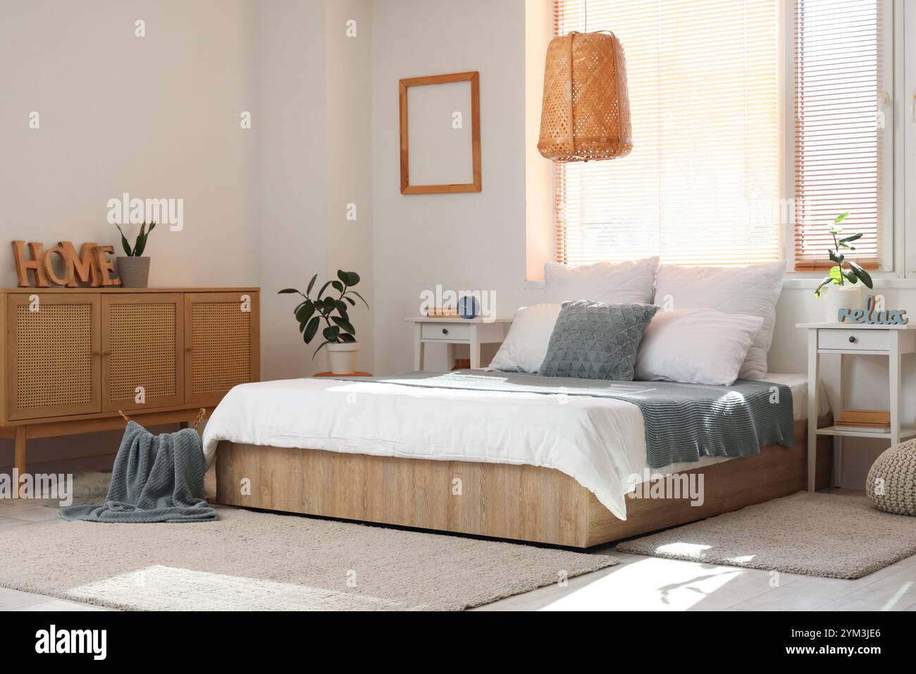 Interior of light bedroom with tables, drawers and alarm clock Stock ...