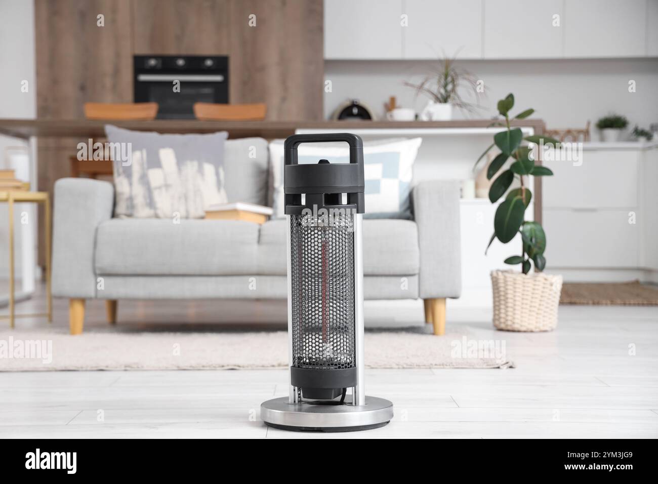 Electric heater on floor in kitchen Stock Photo - Alamy