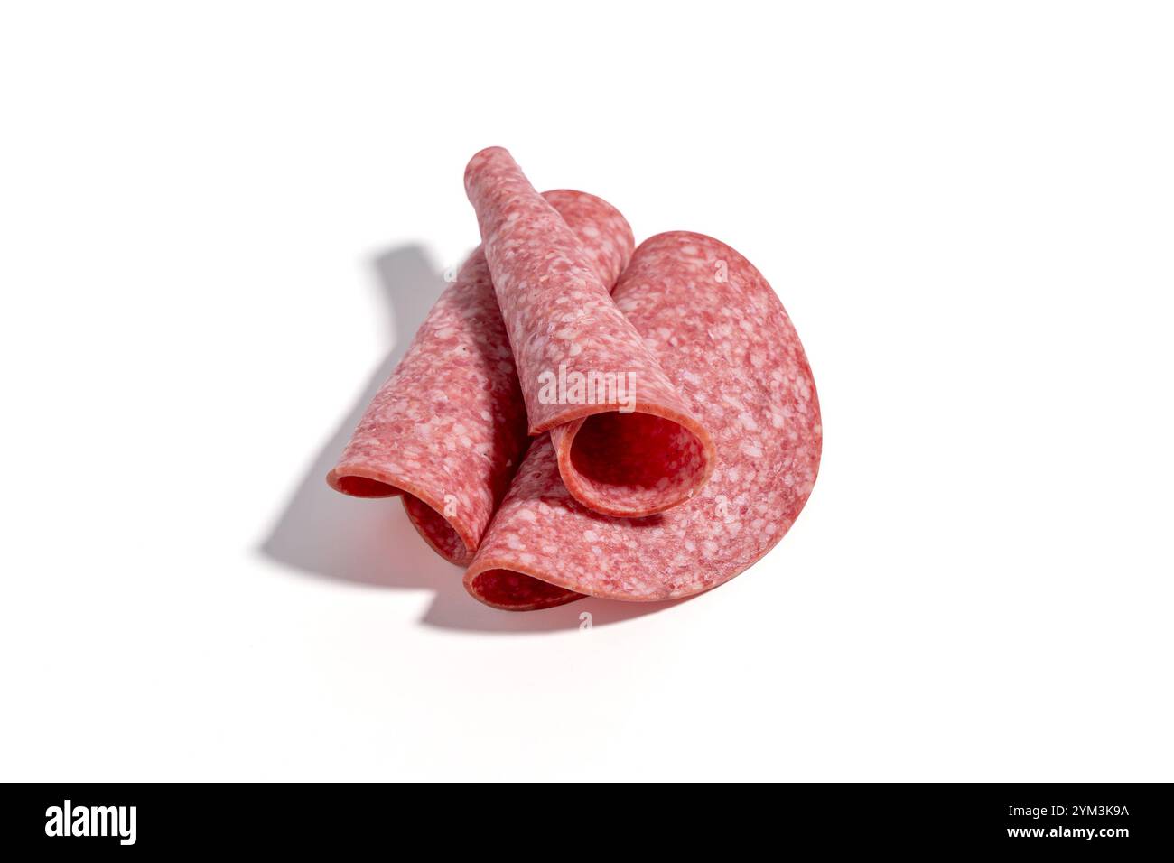 A piece of salami is cut into a spiral. The spiral shape of the salami ...