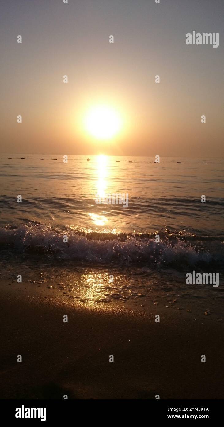 Small wave along with the sun rising at the beach Stock Photo - Alamy