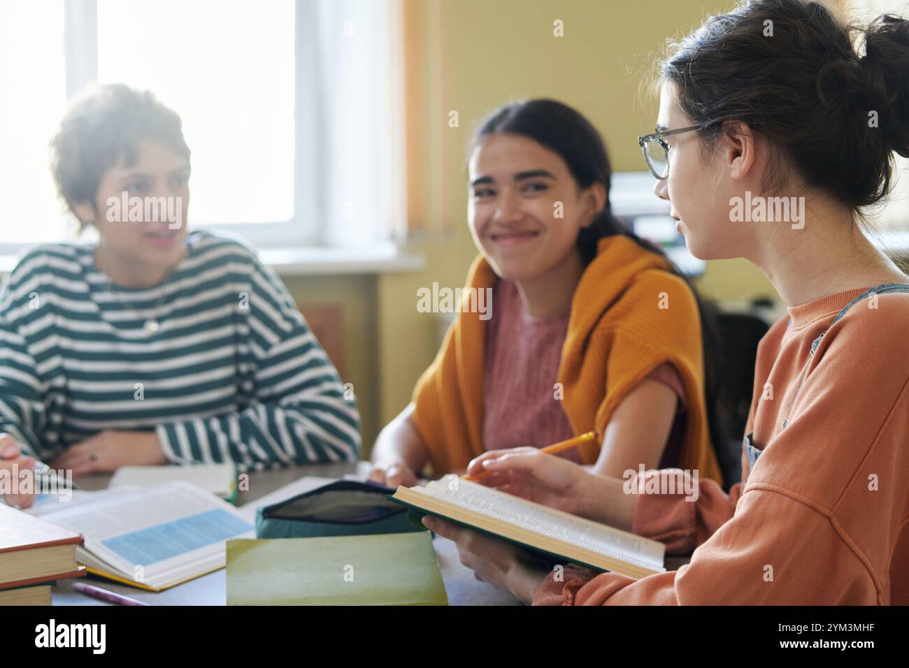 Studying Together in Library with Books and Notebooks Stock Photo - Alamy