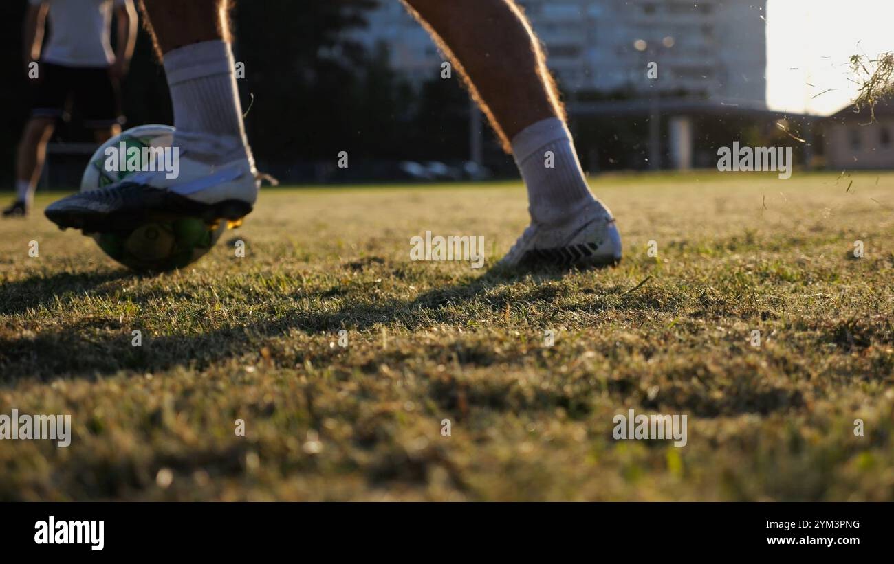 Male feet of professional footballers passing soccer ball on stadium at ...