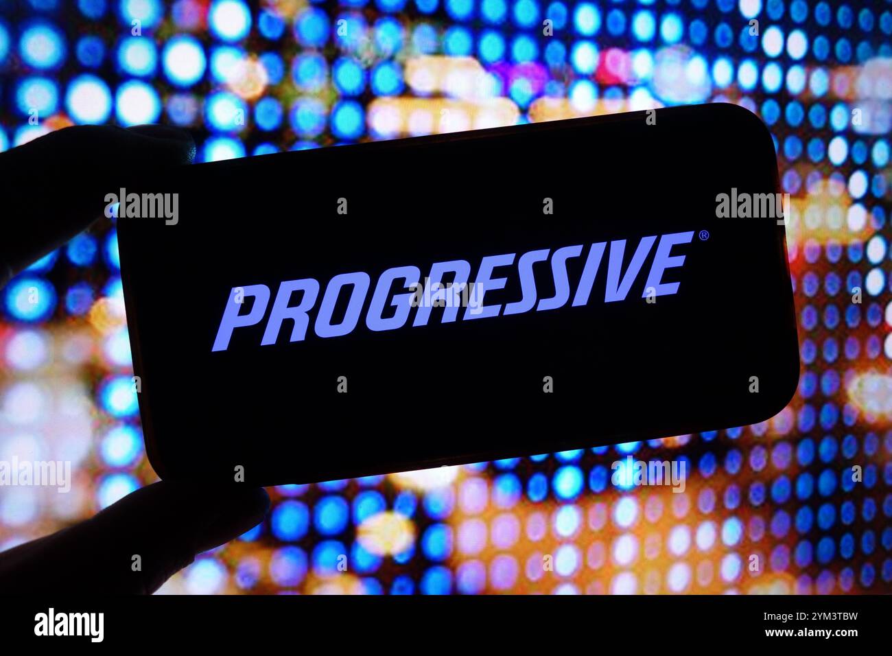 In this photo illustration, the Progressive company logo is seen ...
