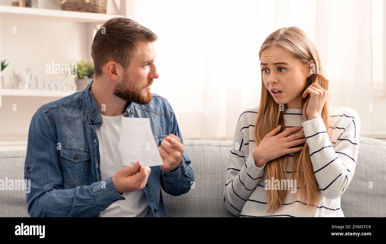 Angry man asking his wife about credit bank bill Stock Photo - Alamy