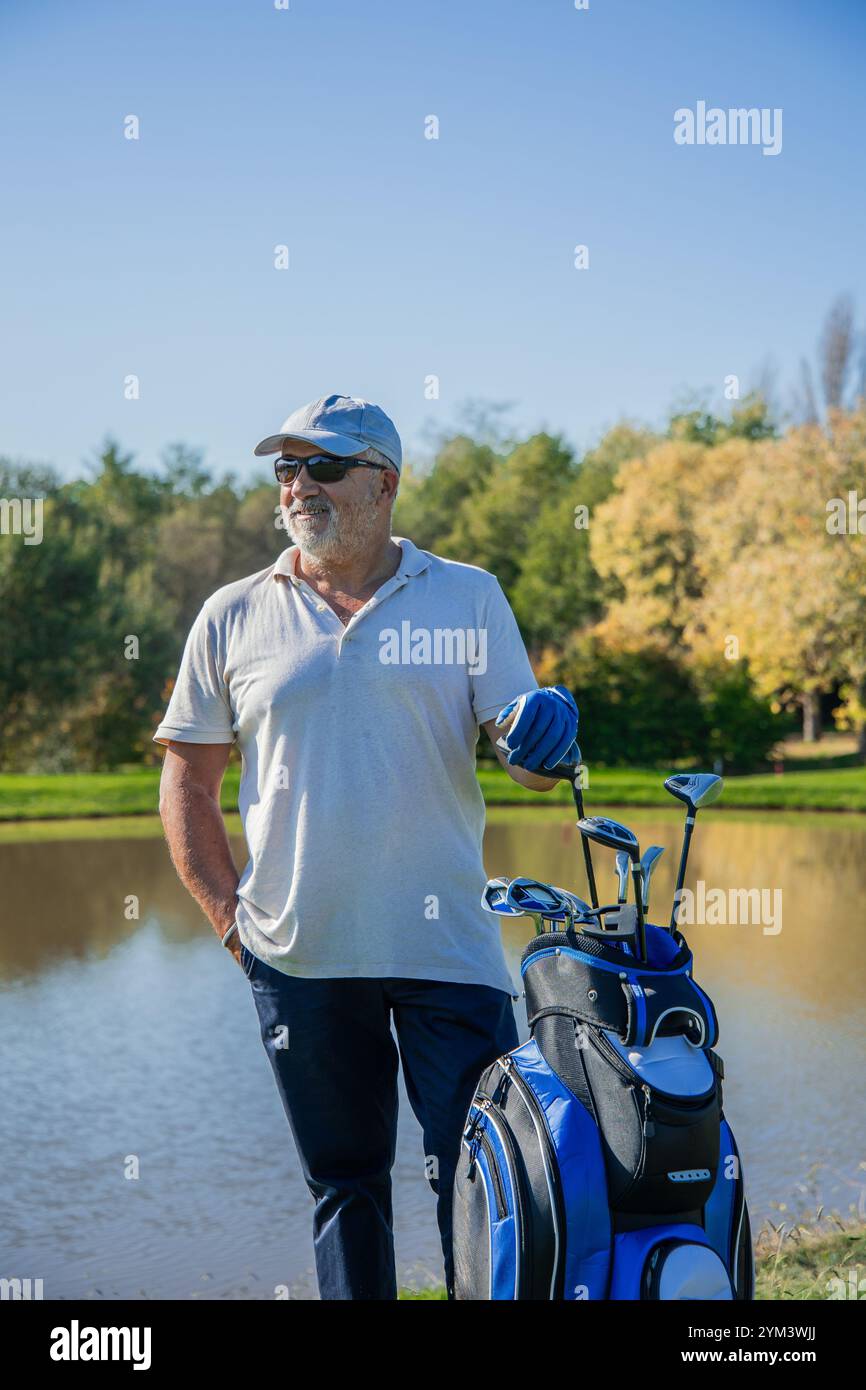 Elderly man is standing on a golf course hi-res stock photography and ...