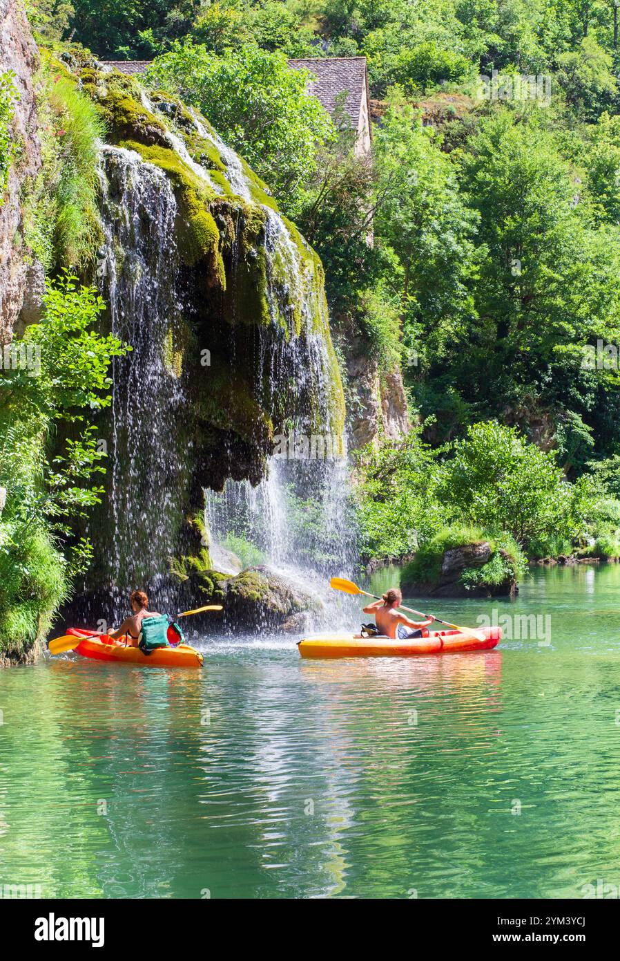 Canoes and waterfall of Saint-Chély-du-Tarn village in the valley of ...