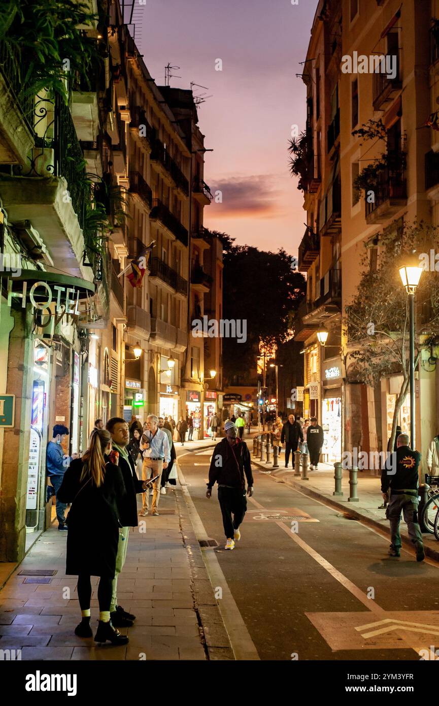 Commuters walk el Carrer Hospital street adjacent of La Rambla in the ...