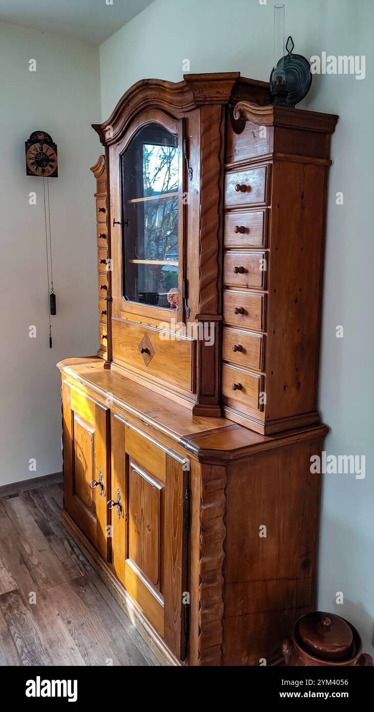 Elegant antique wooden cabinet with glass doors and many drawers ...