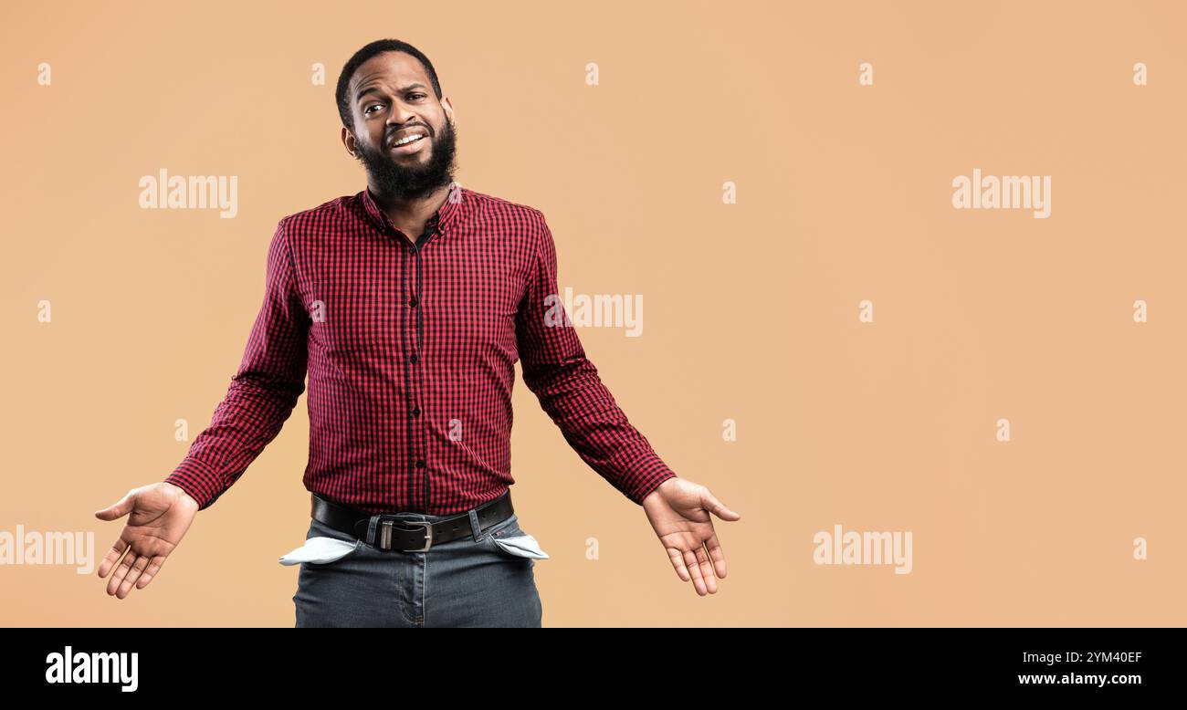 Portrait of black guy showing his empty pockets Stock Photo - Alamy