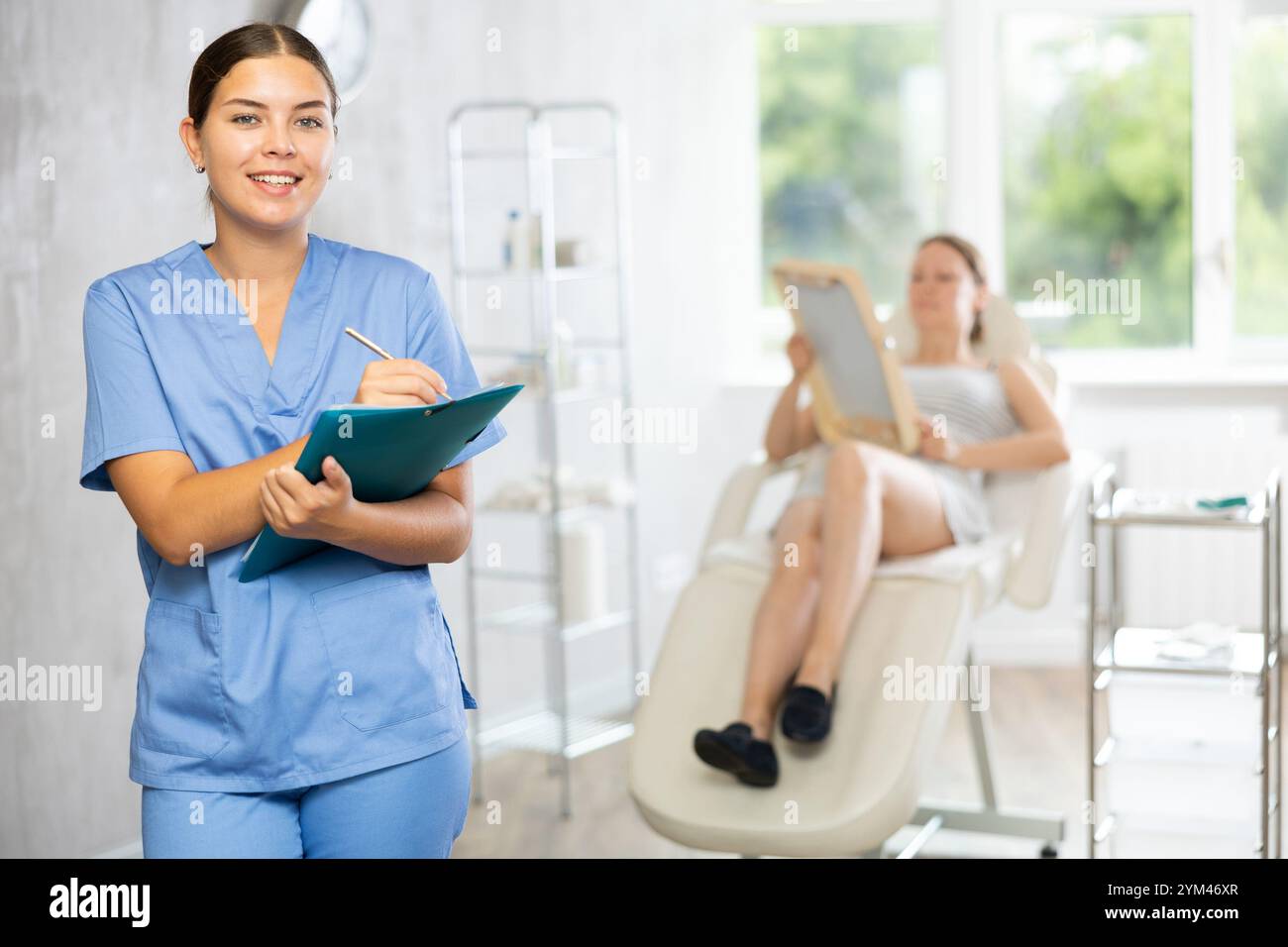 After cosmetic procedure, woman doctor interviews client and enters ...
