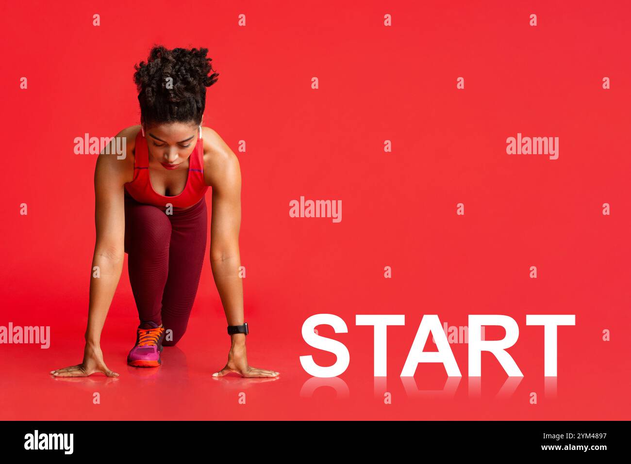 Black Female Athlete In Starting Position Before Run With Lettering ...