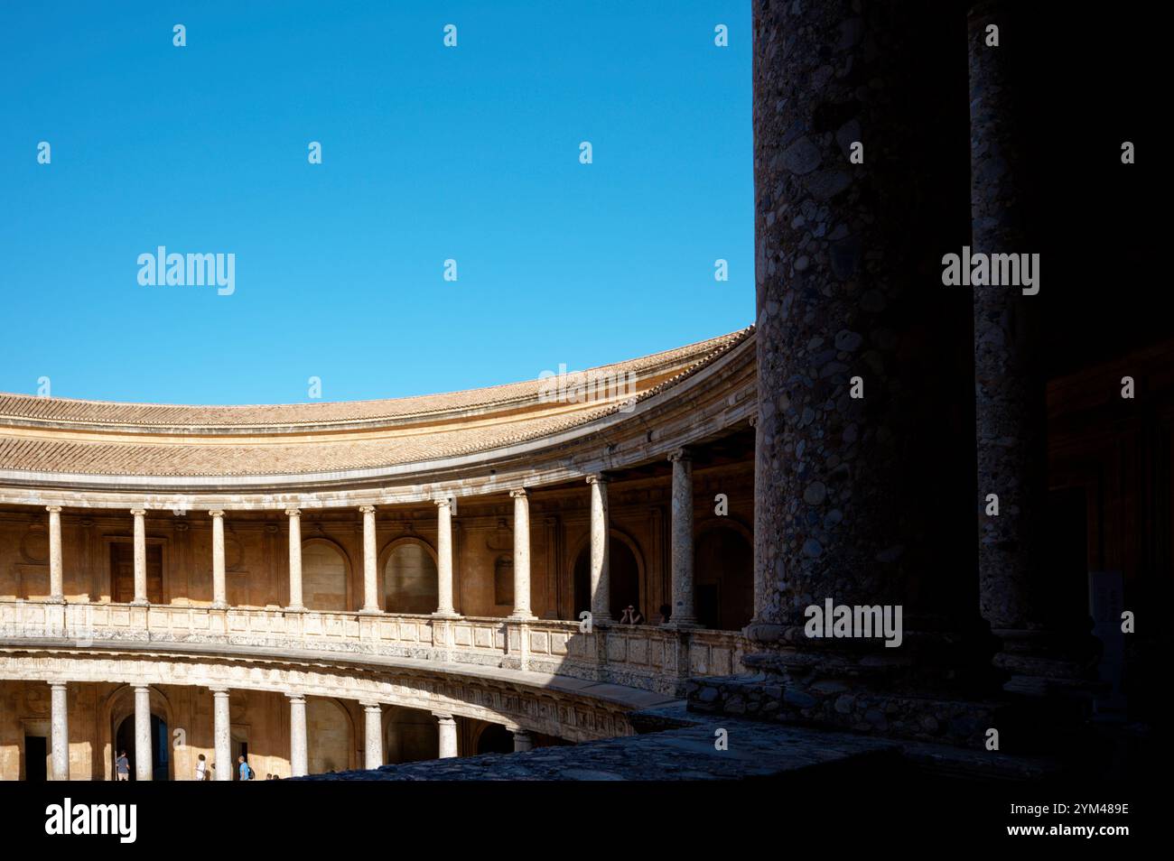 Sunlight highlights the curved colonnades of the Palace of Charles V in ...