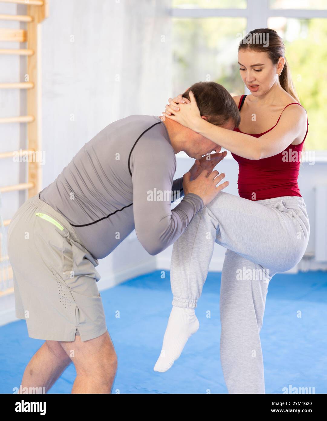 Adult man and young woman training self-defense techniques Stock Photo ...