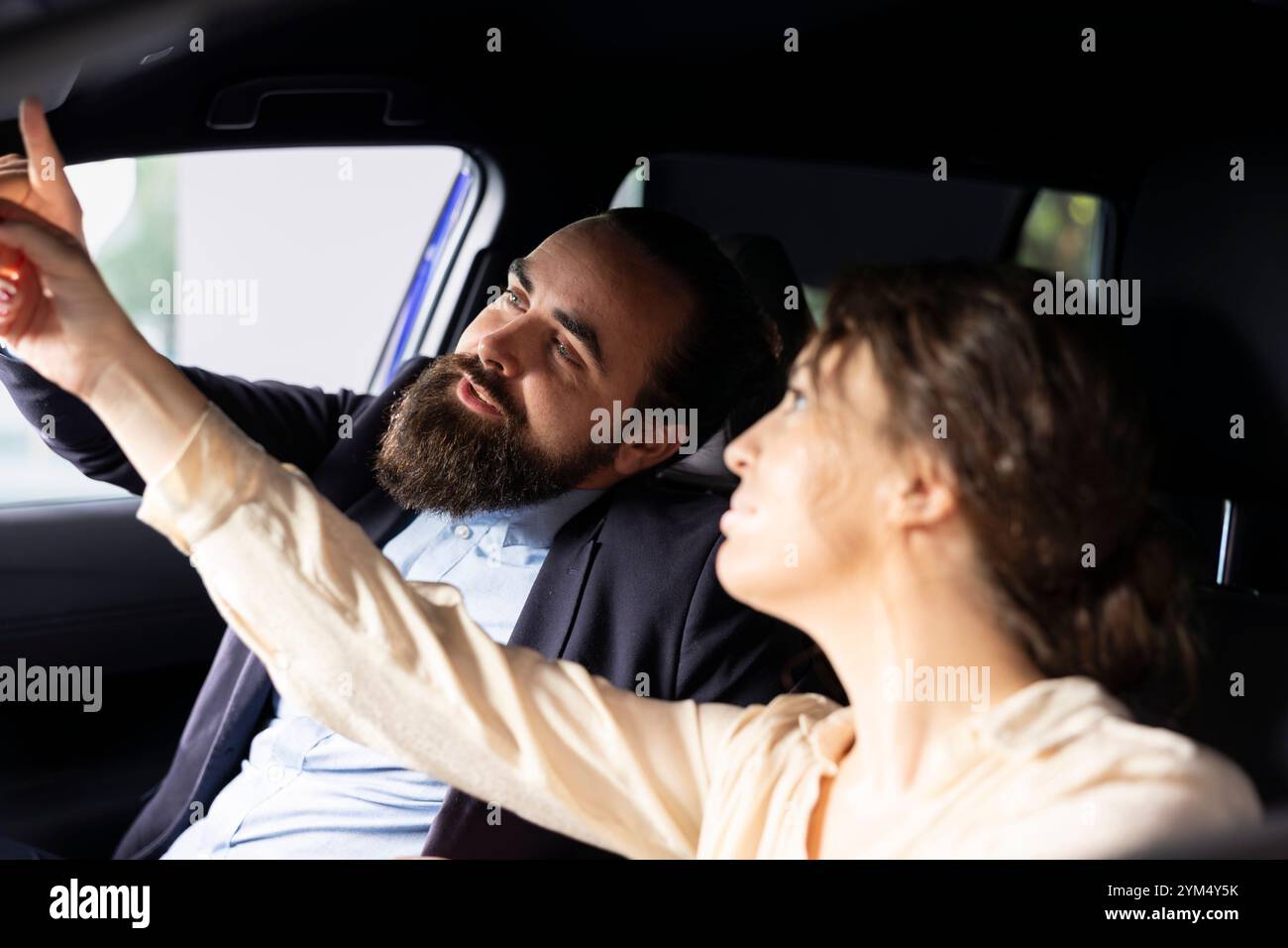 Salesman showing car features to customer doing test drive, hoping to ...