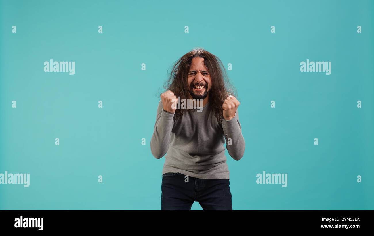 Man pulling hair in frustration, showing angry facial expression ...