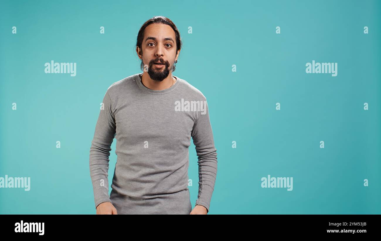 Portrait of cheerful wide eyed man looking around in awe, captivated by ...