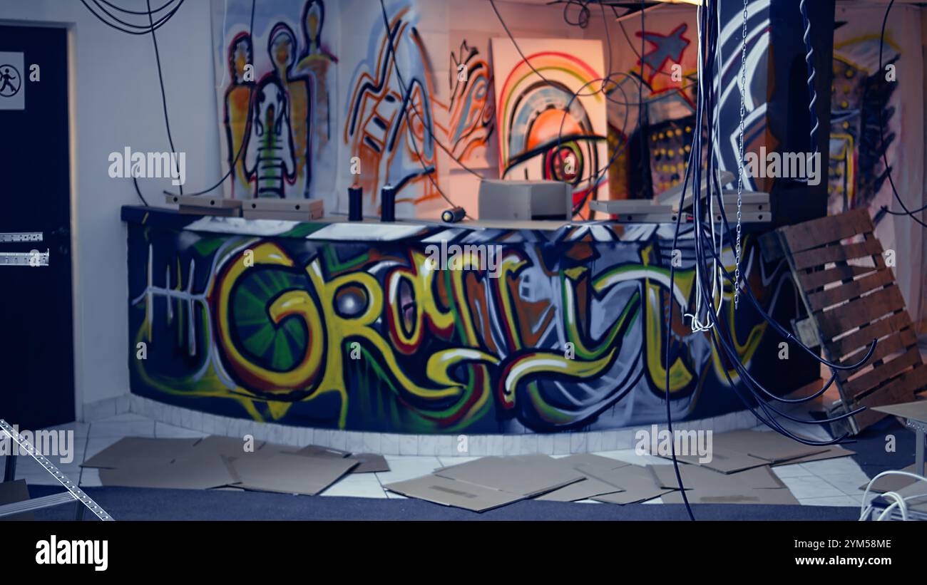 Junk and hanging electric cables left over in old degraded building by ...