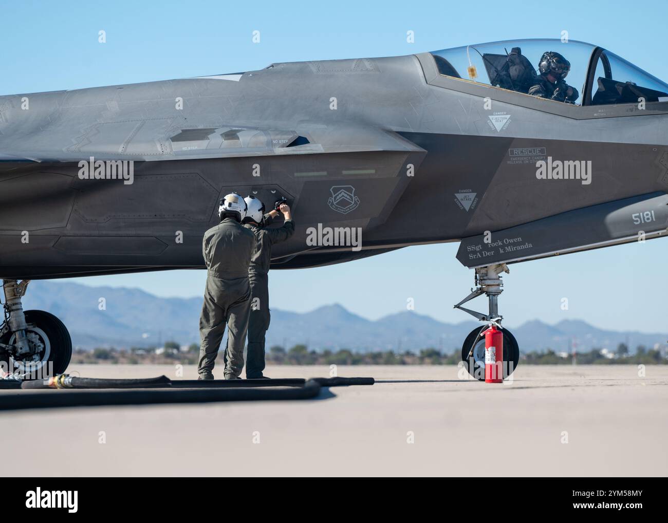 U.S. Marines hook up a refueling hose to an F-35 Lightning II aircraft ...