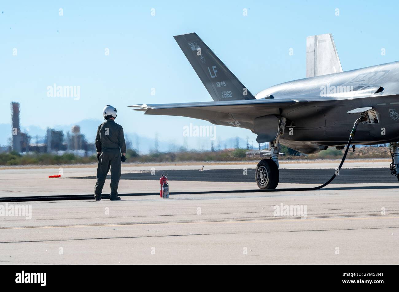 A U.S. Marine waits for an F-35 Lightning II aircraft assigned to the ...