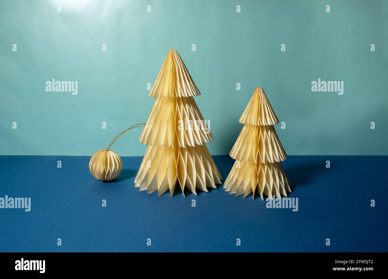 Festive beige Christmas trees of different size created from paper with ...