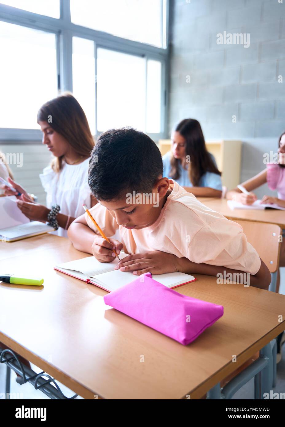 Latin boy elementary school student concentrated doing teacher lesson ...