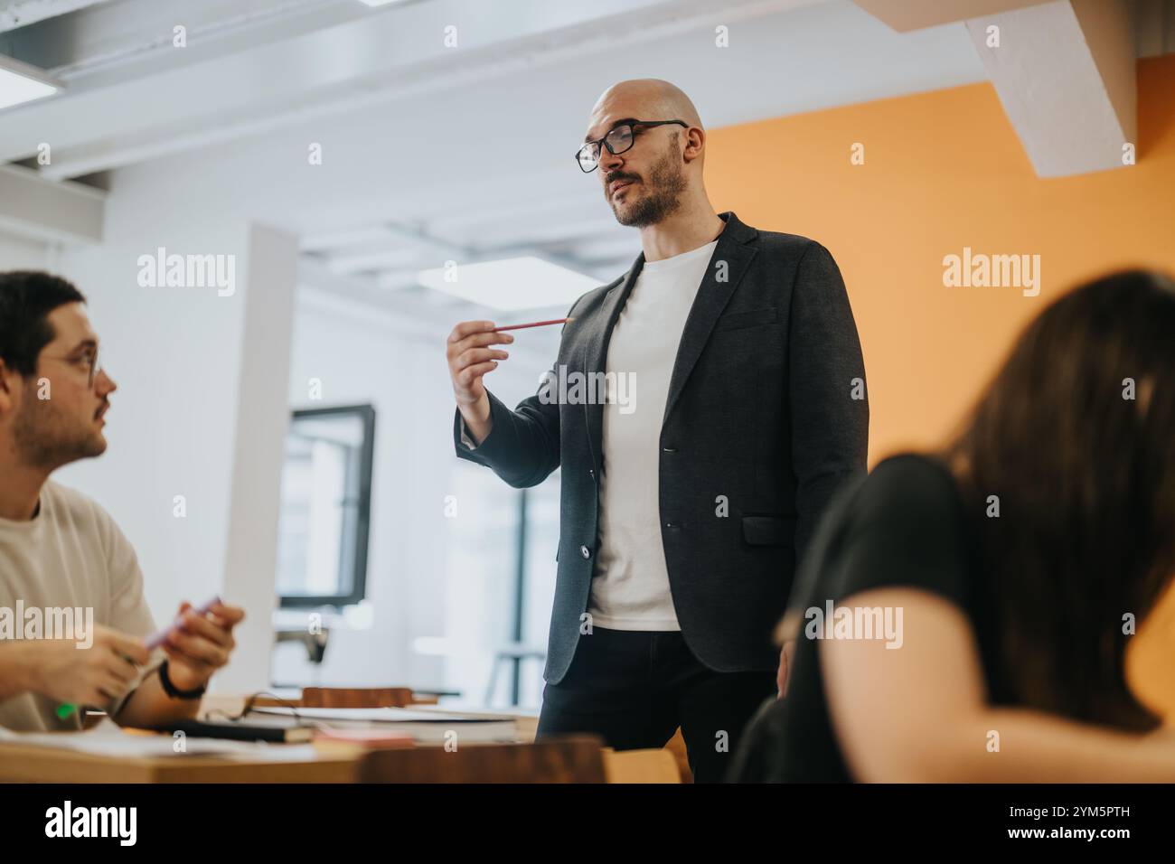 High school classroom with teacher interacting with students Stock ...