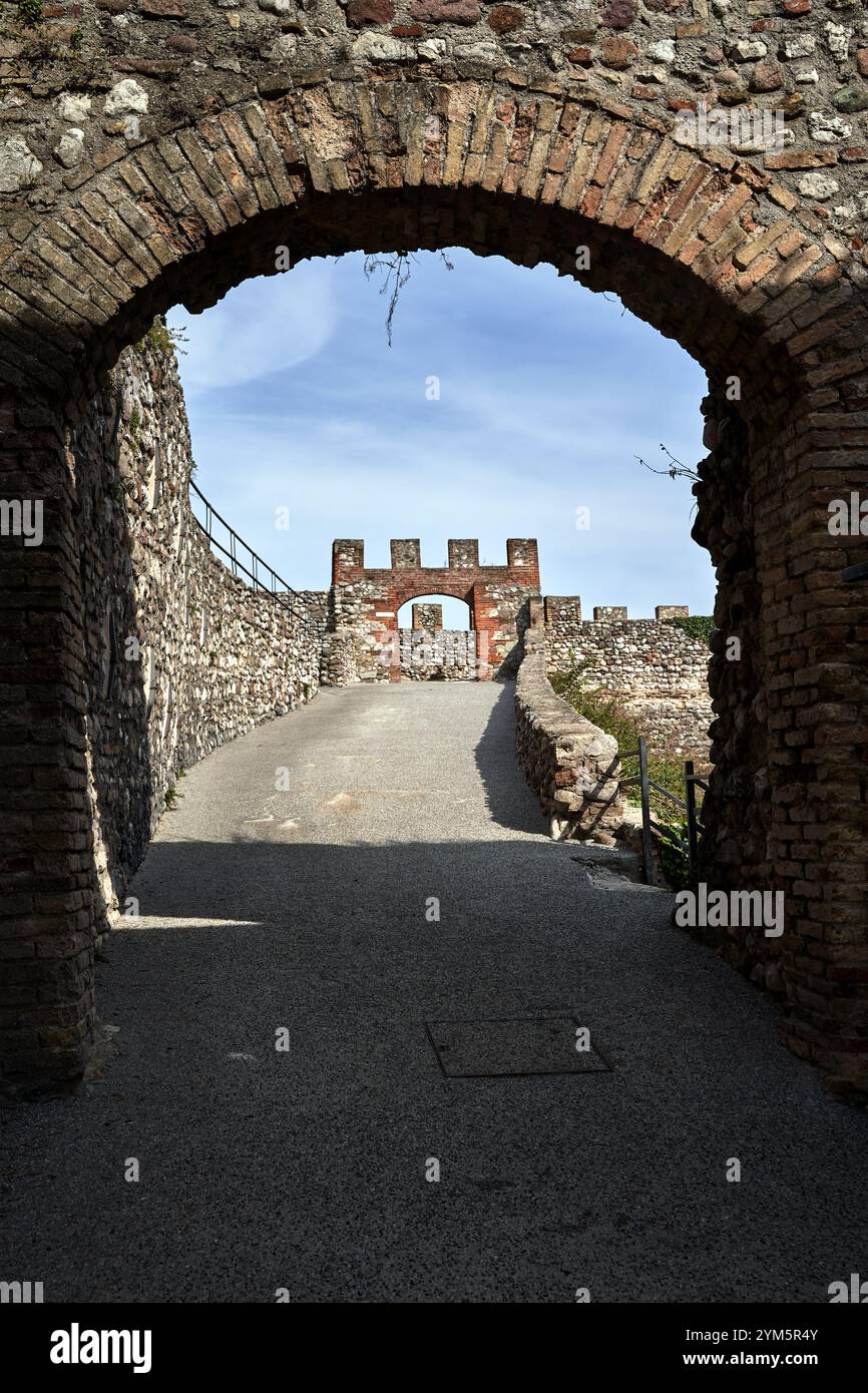 Stone gate and defensive walls of a medieval castle on Lake Garda ...