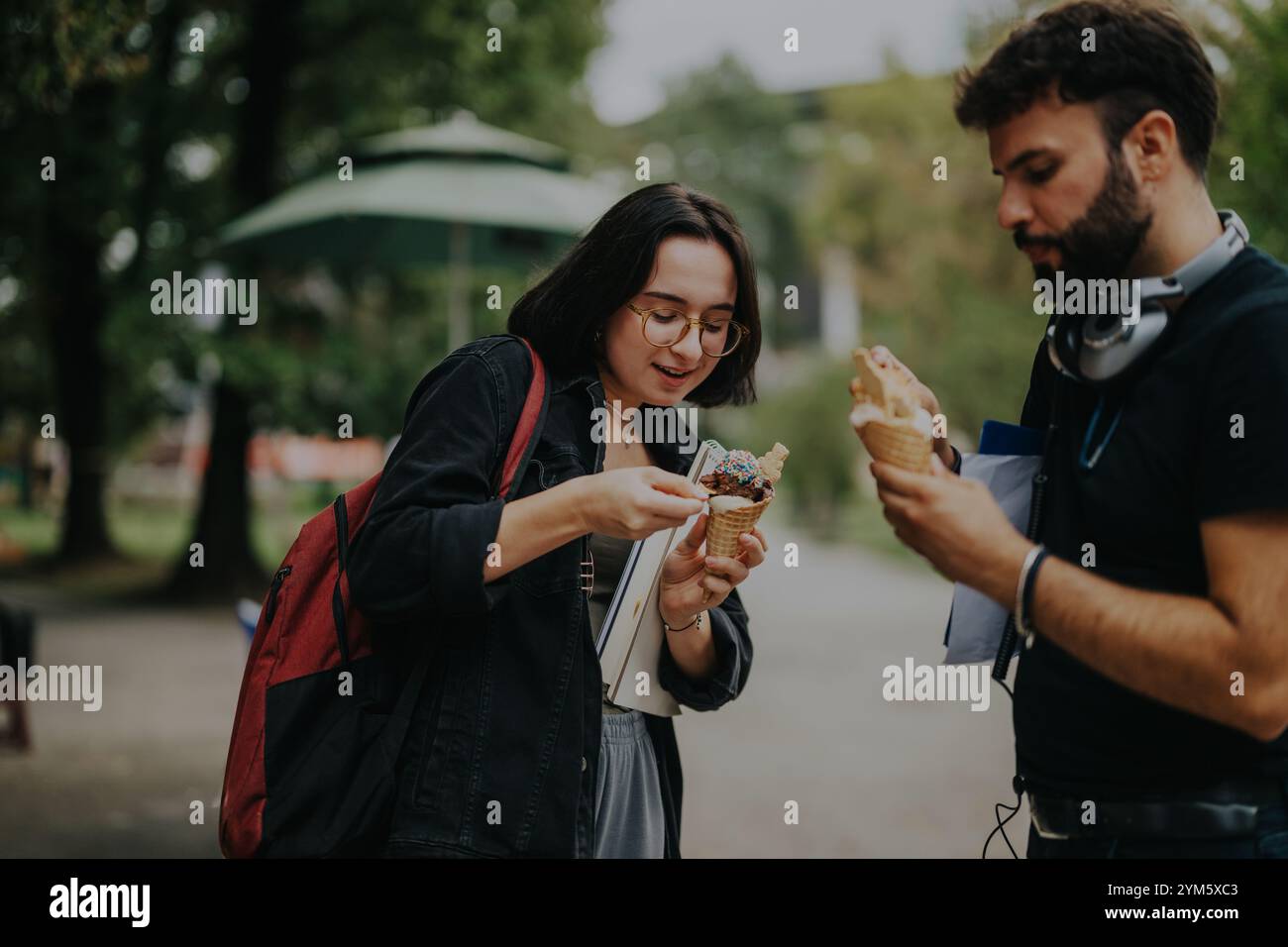 Multicultural students enjoying ice cream in the park during class break Stock Photo - Alamy