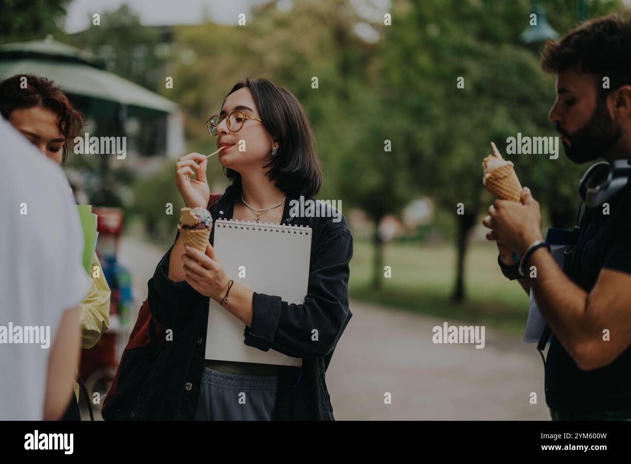 Multicultural students enjoying ice cream together at the park Stock Photo - Alamy