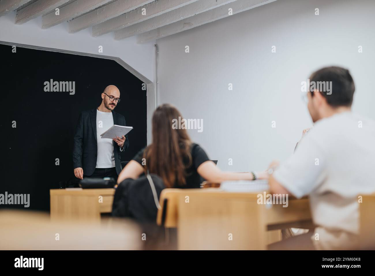 Teacher leading a high school class session with attentive students ...