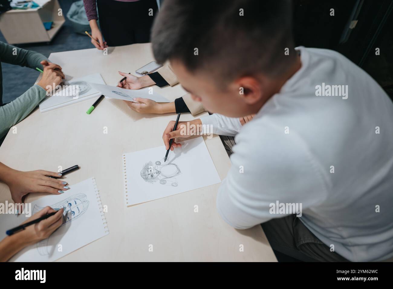 Students in a classroom engaging in a sketching exercise together Stock ...