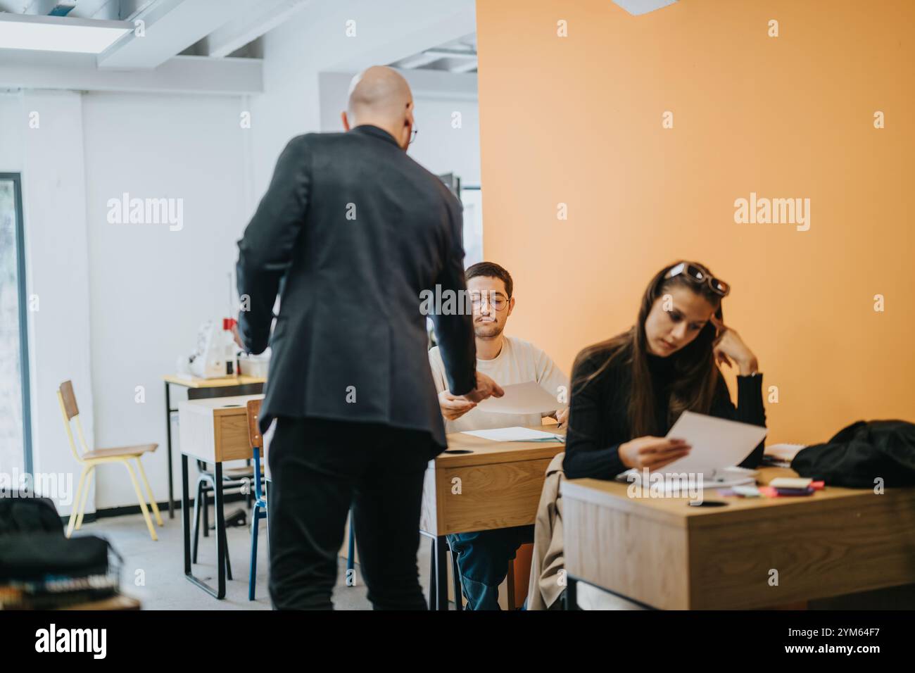 Teacher writing papers classroom hi-res stock photography and images ...