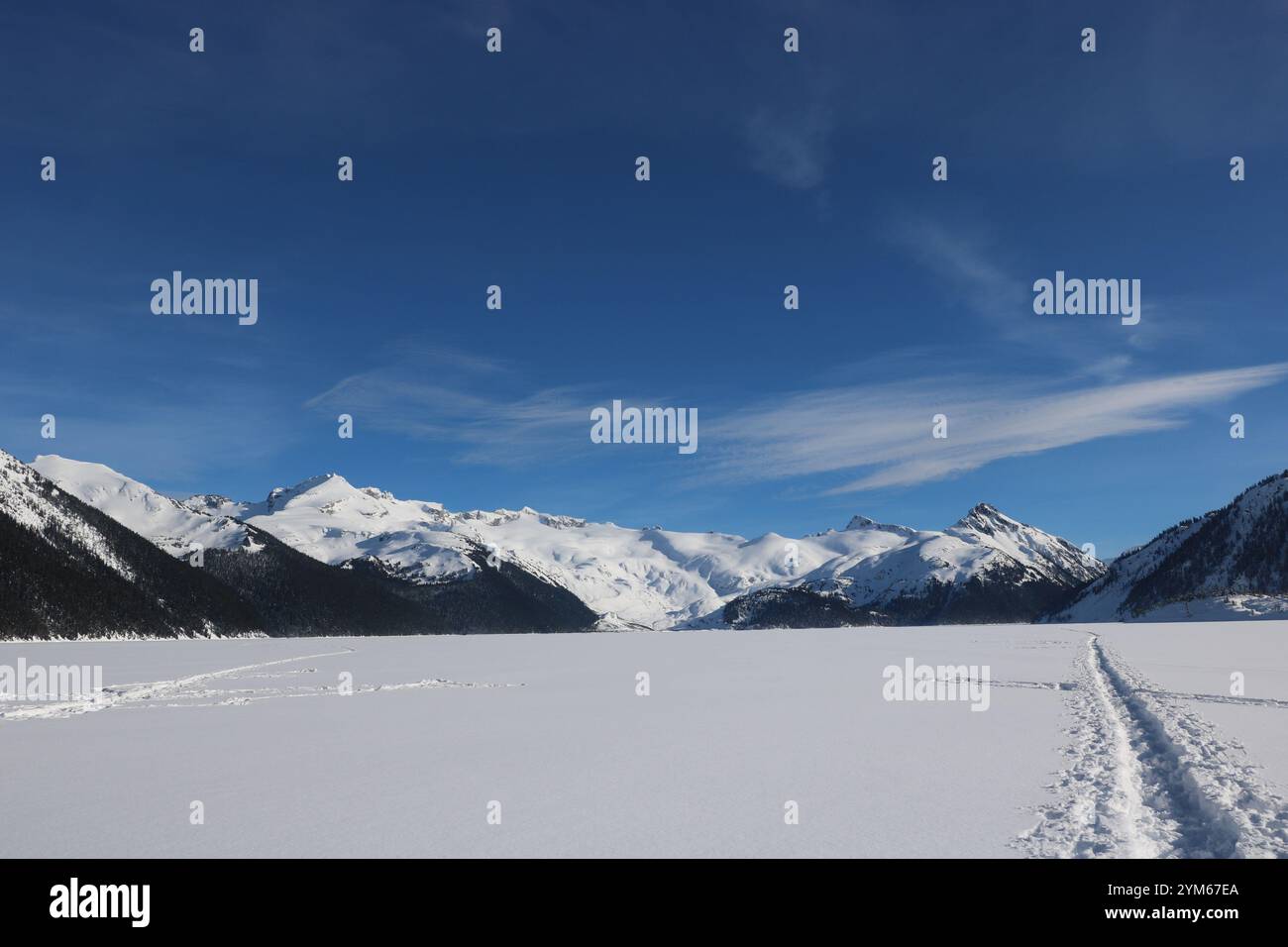 Snowy Mountain Peaks and Frozen Lake Under Clear Blue Sky in Remote ...