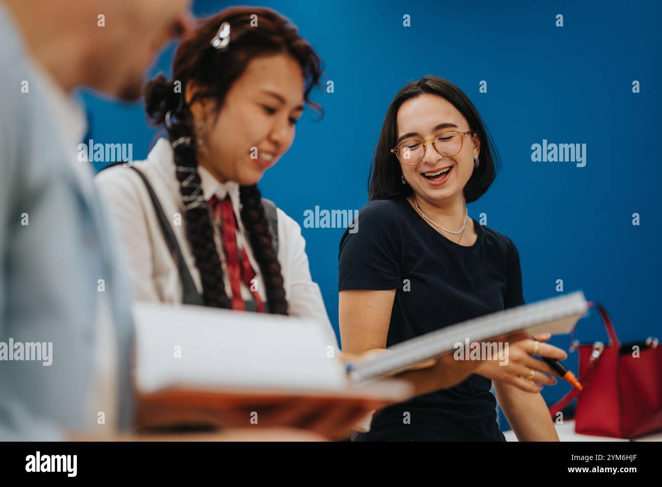 Students laughing and studying together in a bright classroom Stock ...