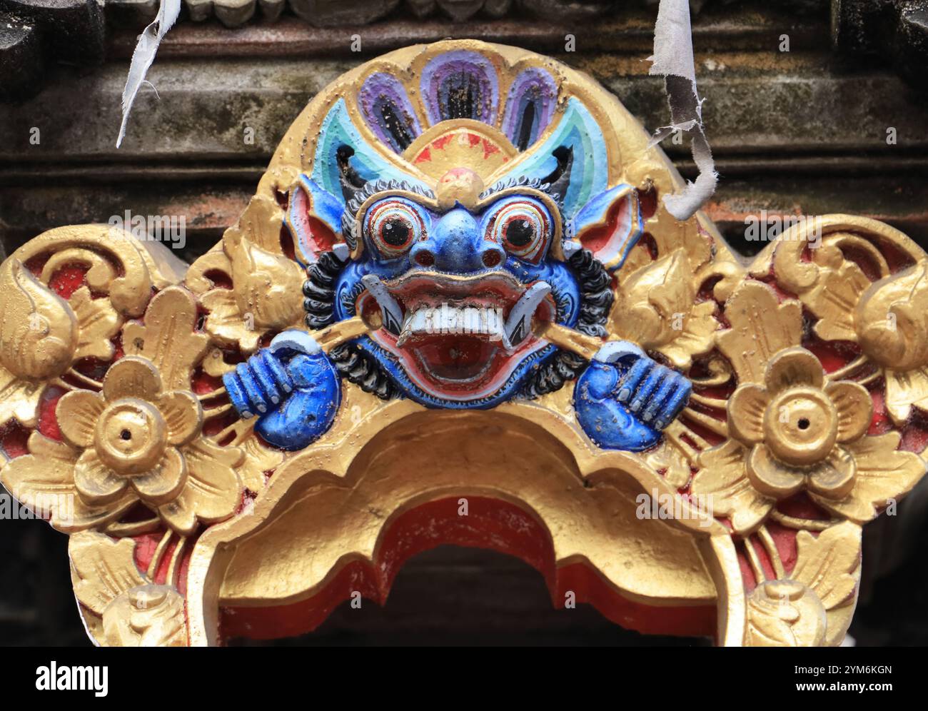 Traditional Balinese mask carved and painted on te portal of a hindu ...
