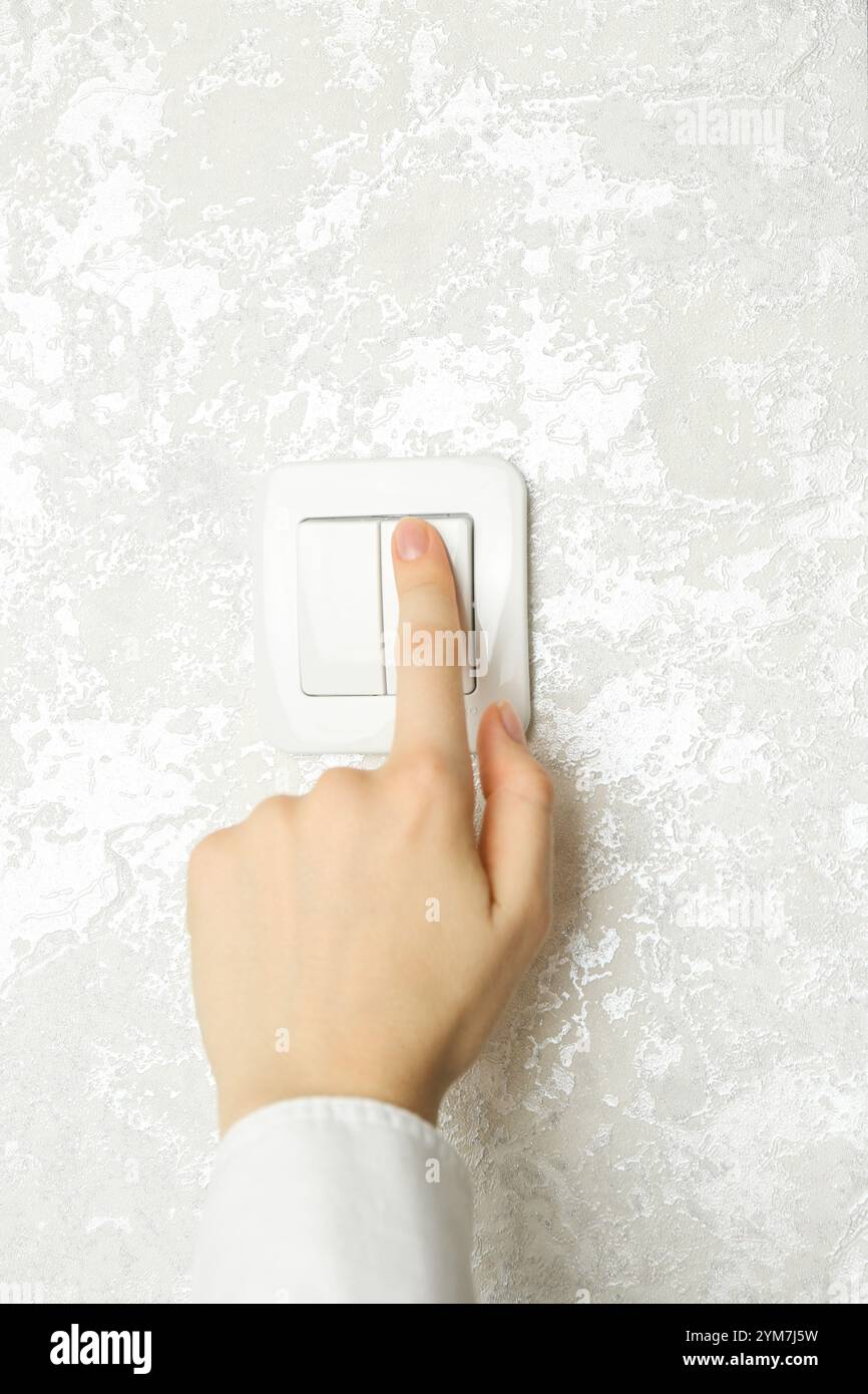 Woman turning light switch on, closeup view Stock Photo - Alamy