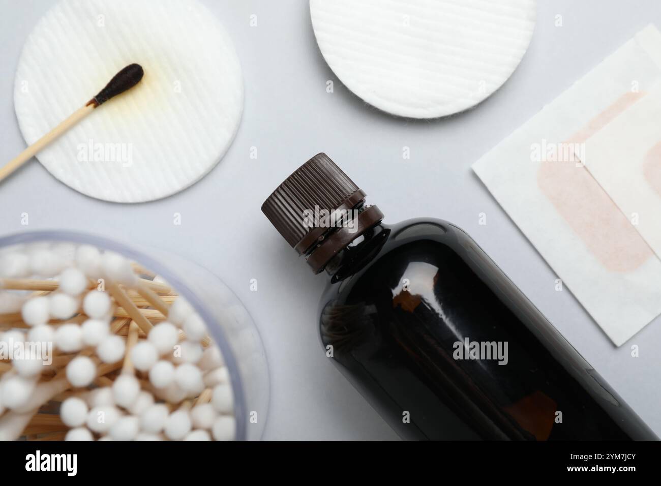 Topical iodine and other first aid kit components on light grey ...