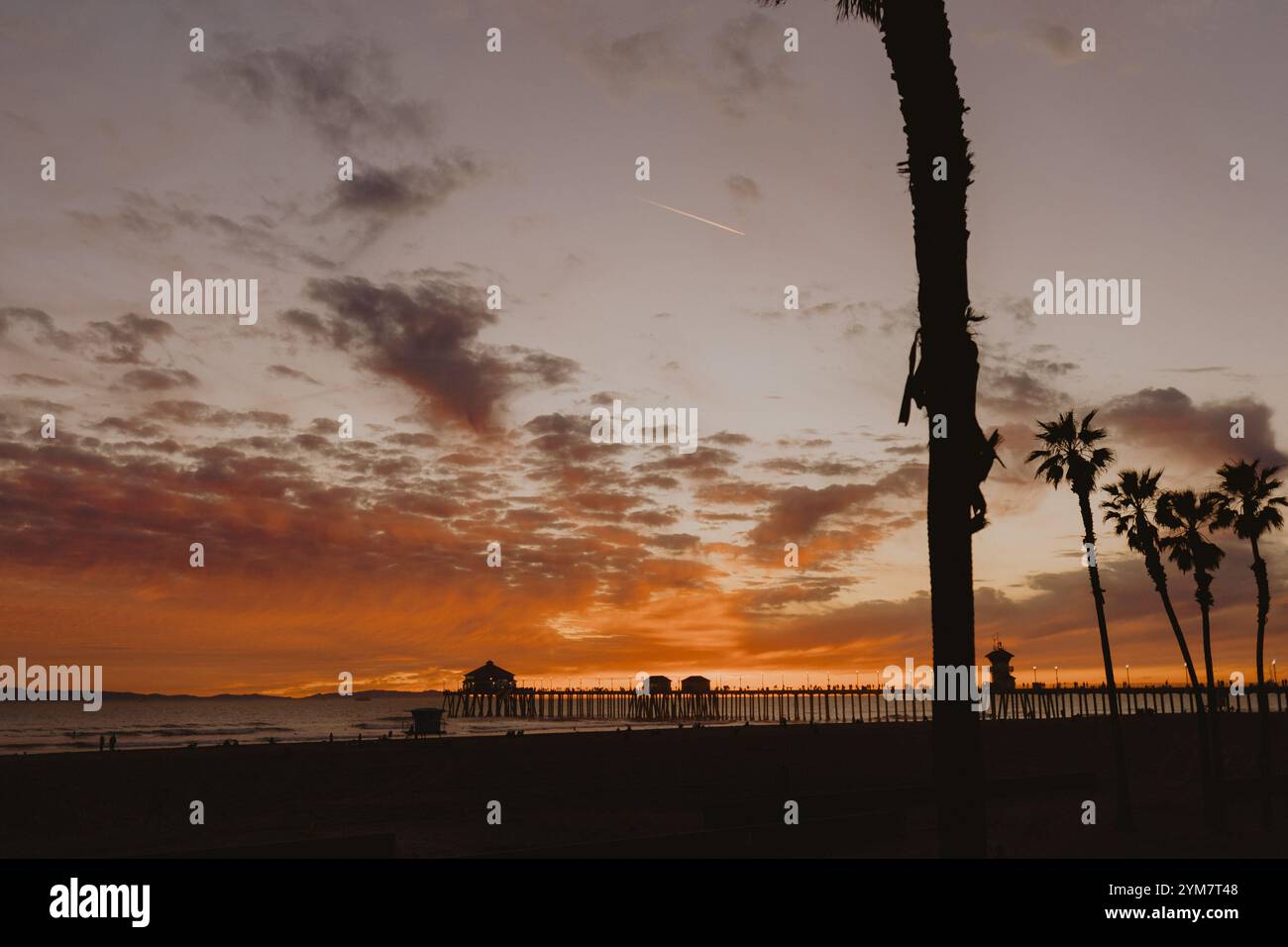 Huntington Beach Pier at sunset with vibrant skies, serene waves, and ...