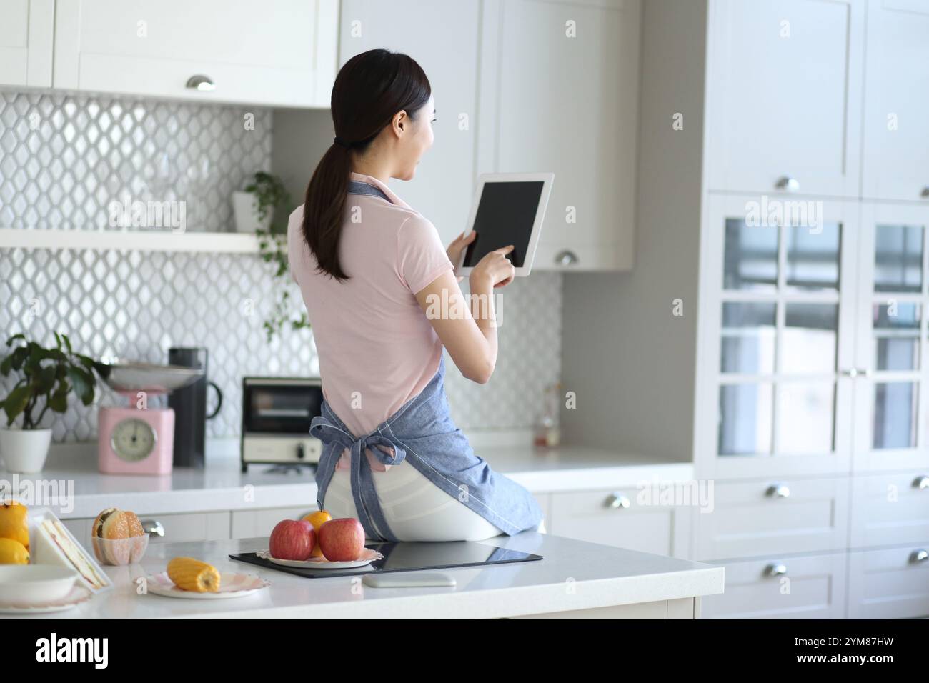 Young woman operating tablet hi-res stock photography and images - Alamy