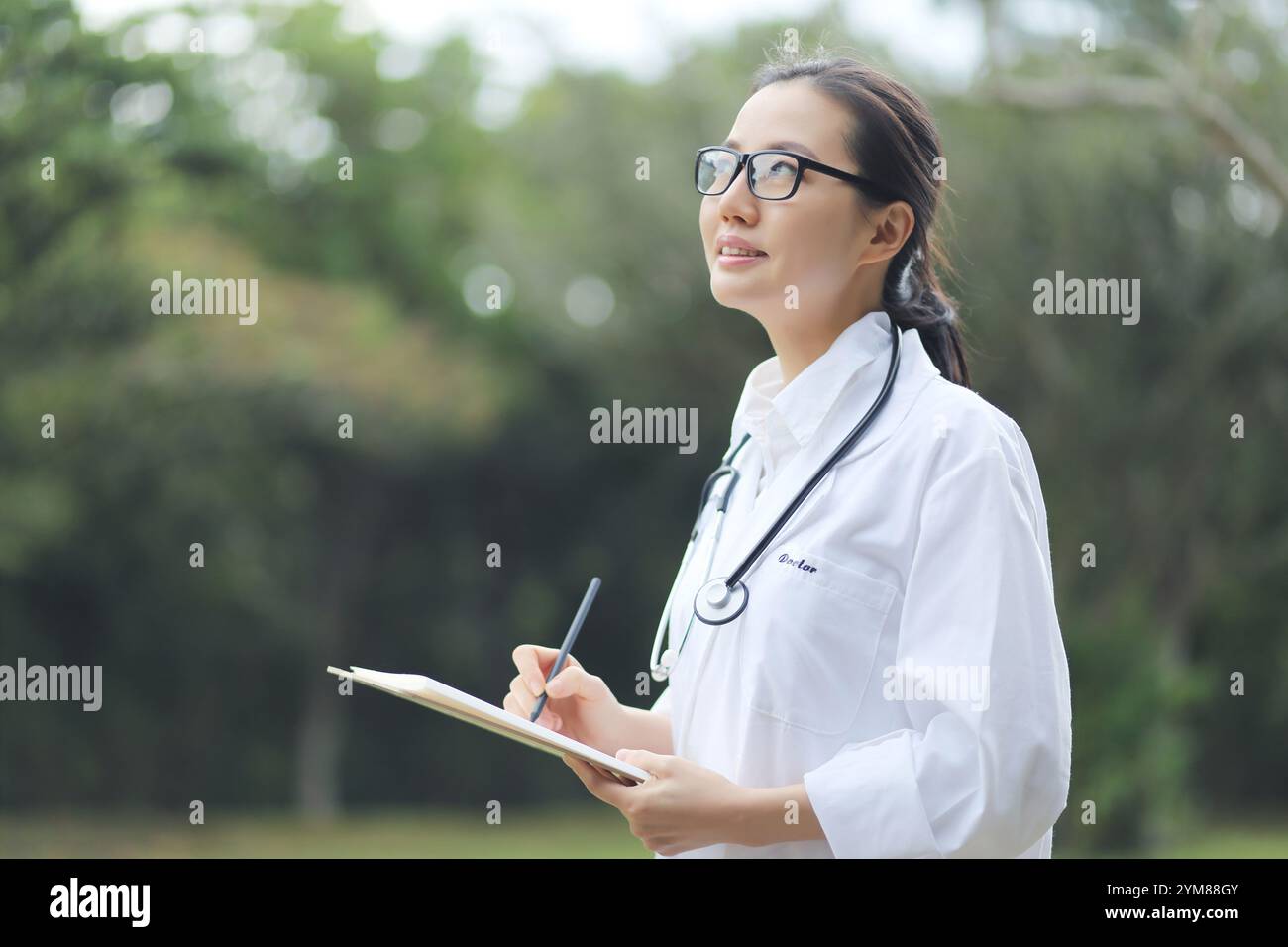 Female doctor taking notes Stock Photo - Alamy