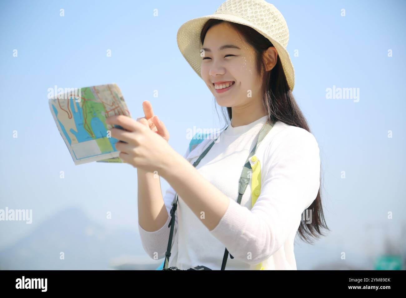 Woman holding a map Stock Photo - Alamy