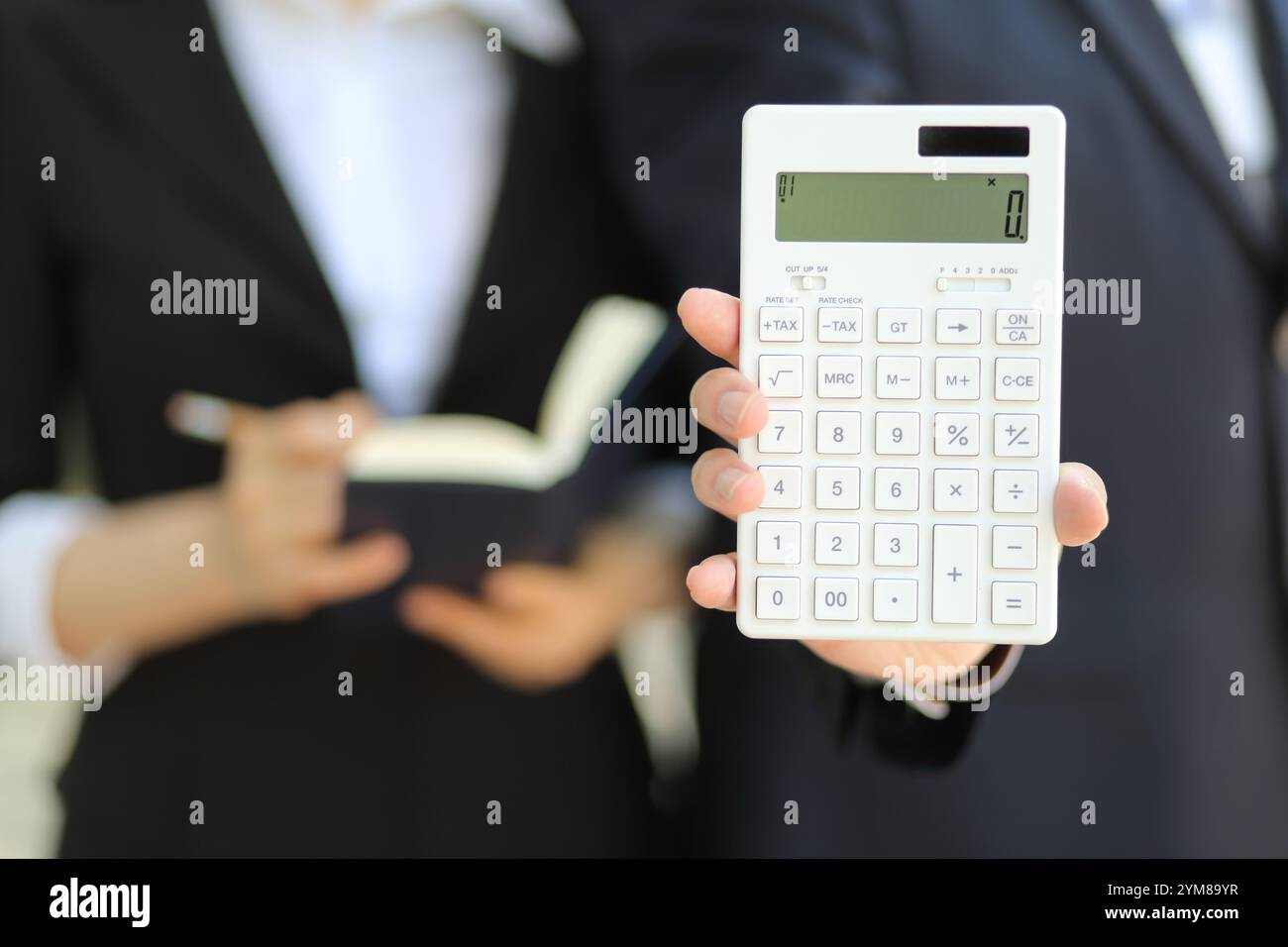 Business man holding calculator hi-res stock photography and images - Alamy