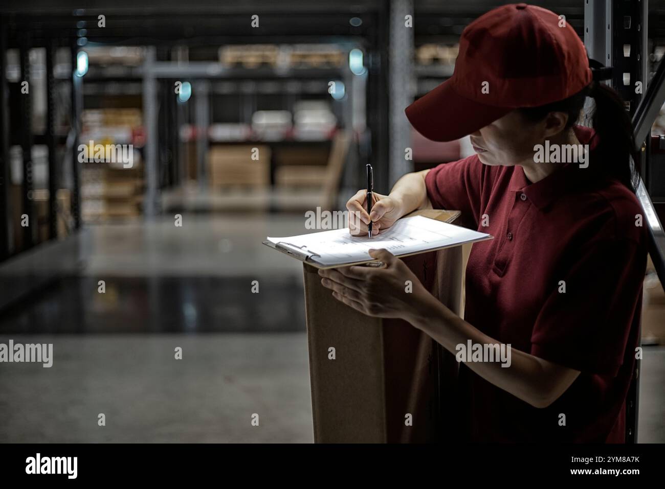 Logistics centre staff taking notes inside the warehouse Stock Photo ...